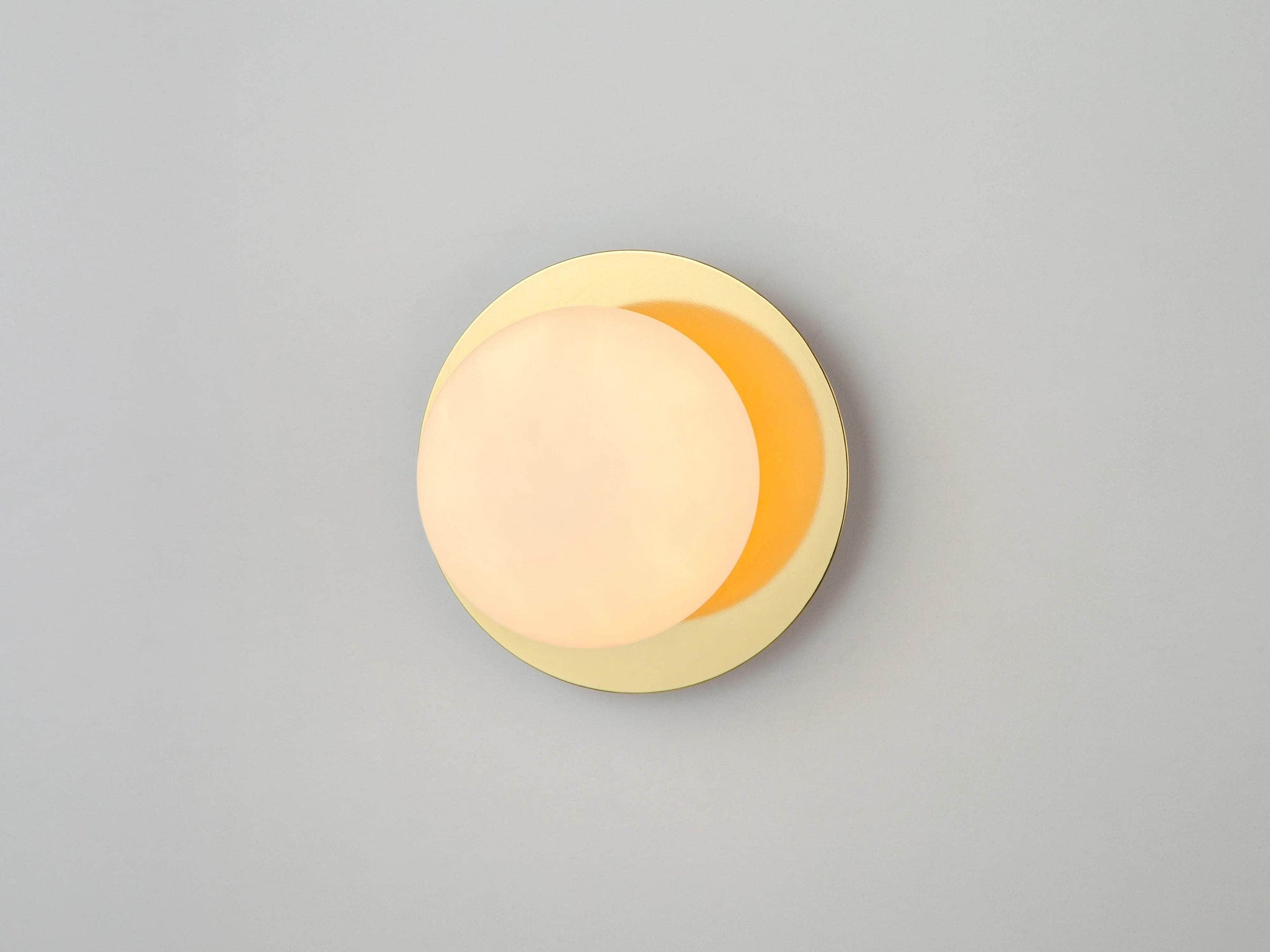 Brass opal disc wall light | Maison Flâneur